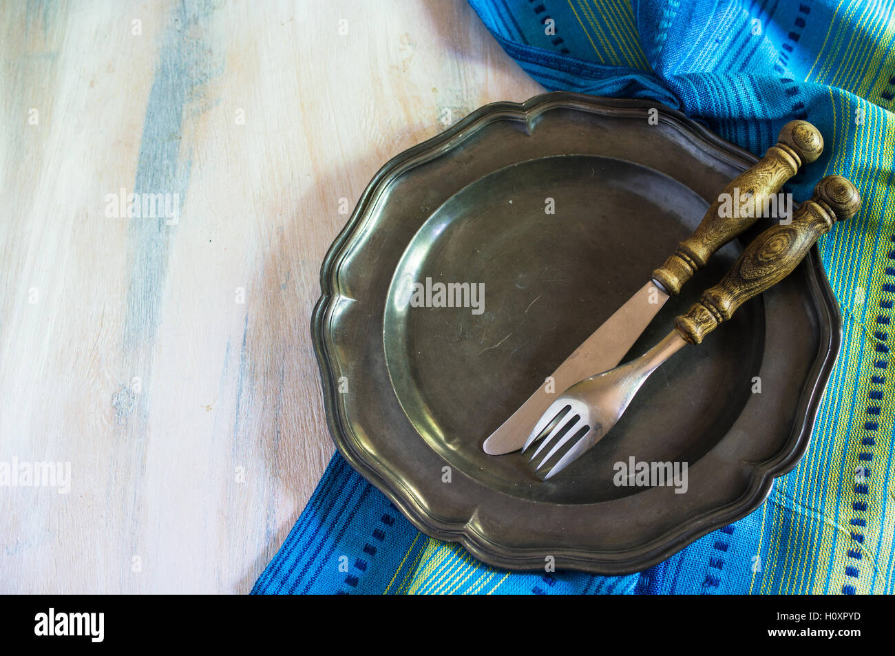 Table setting with vintage porcelain plates and silverware on rustic ...