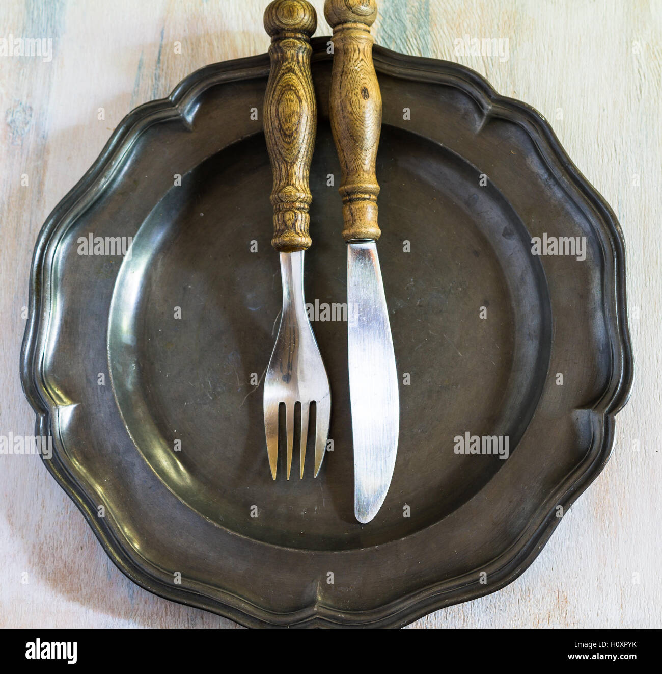 Table setting with vintage porcelain plates and silverware on rustic ...