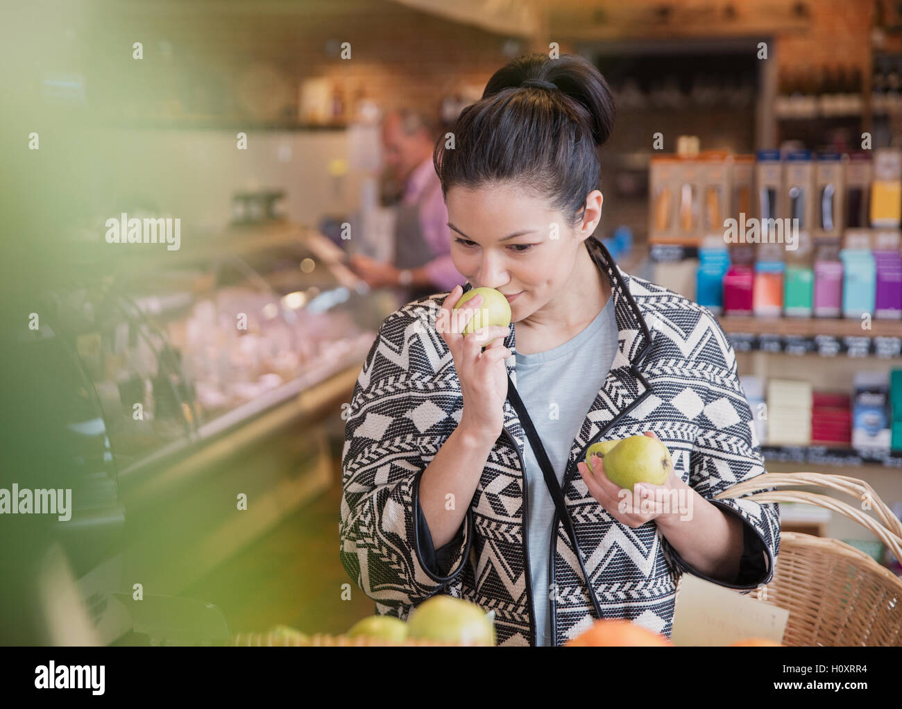 Woman smelling fruit at grocery store hi-res stock photography and ...