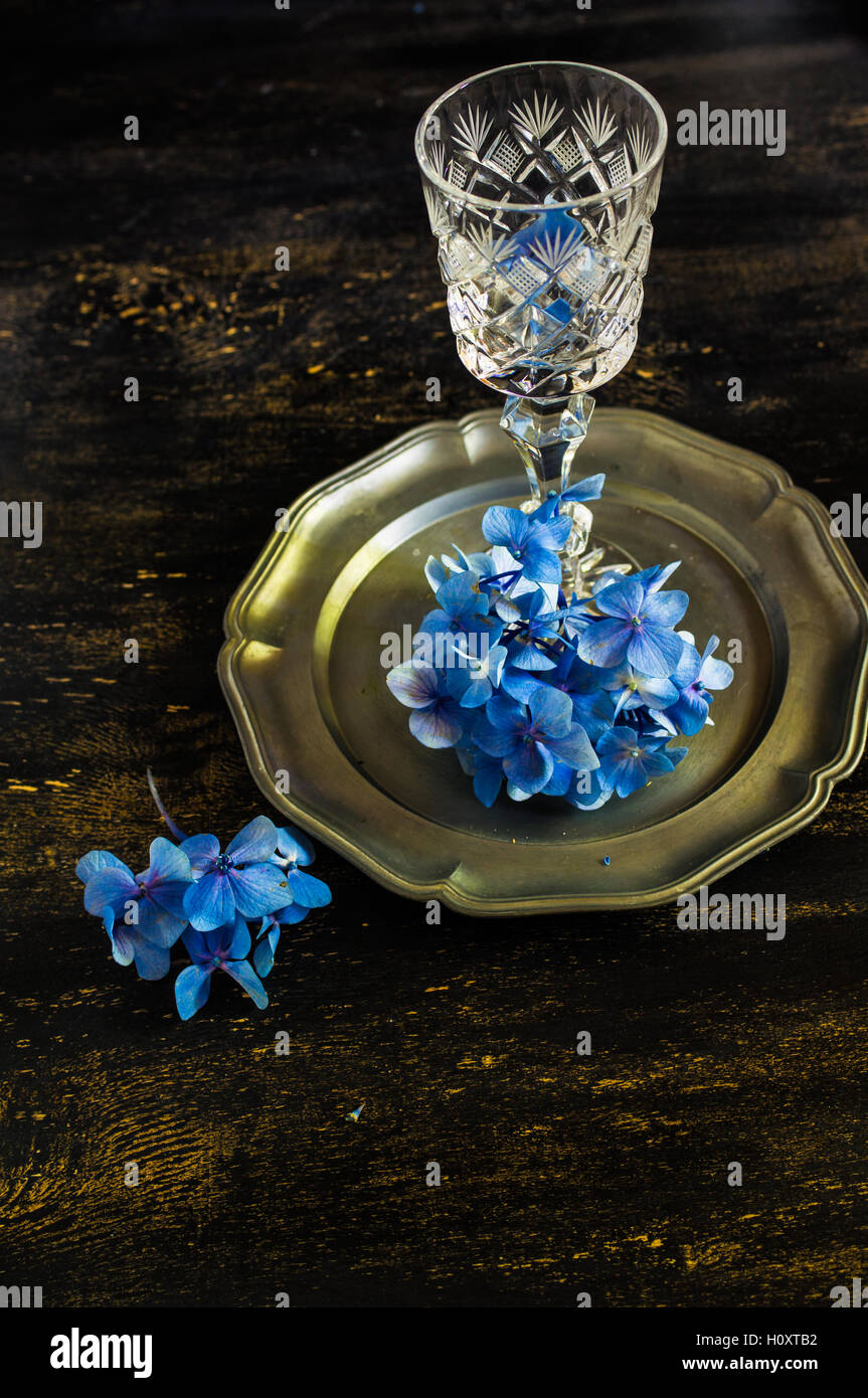 Vintage style table setting with fresh blue hydrangea flowers on rustic ...