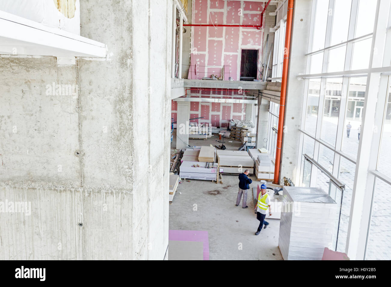 View on indoor construction site of unfinished modern large showroom ...