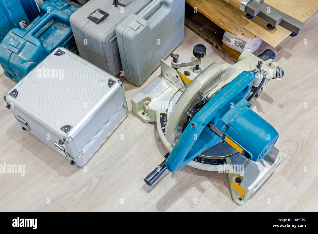 Various plastic tool boxes are on laminate floor with a lot of ...