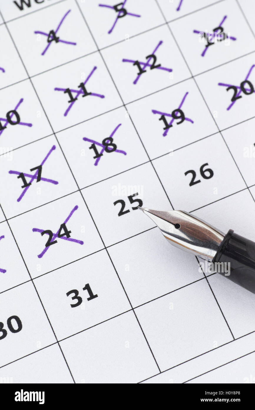 Fountain pen marking days on calendar Stock Photo - Alamy