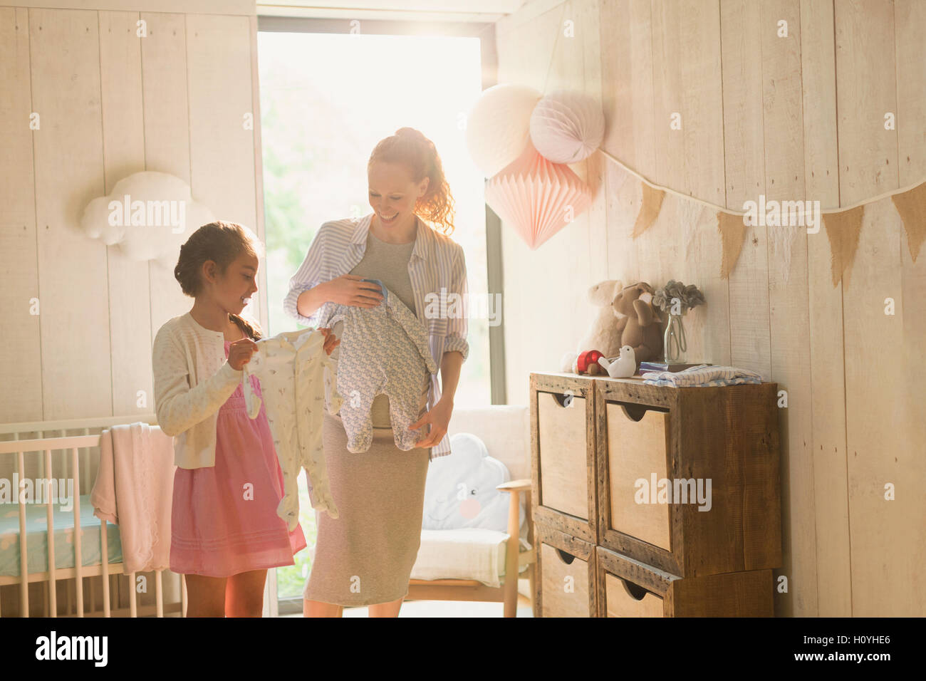Mother and daughter sharing clothes hi-res stock photography and images ...