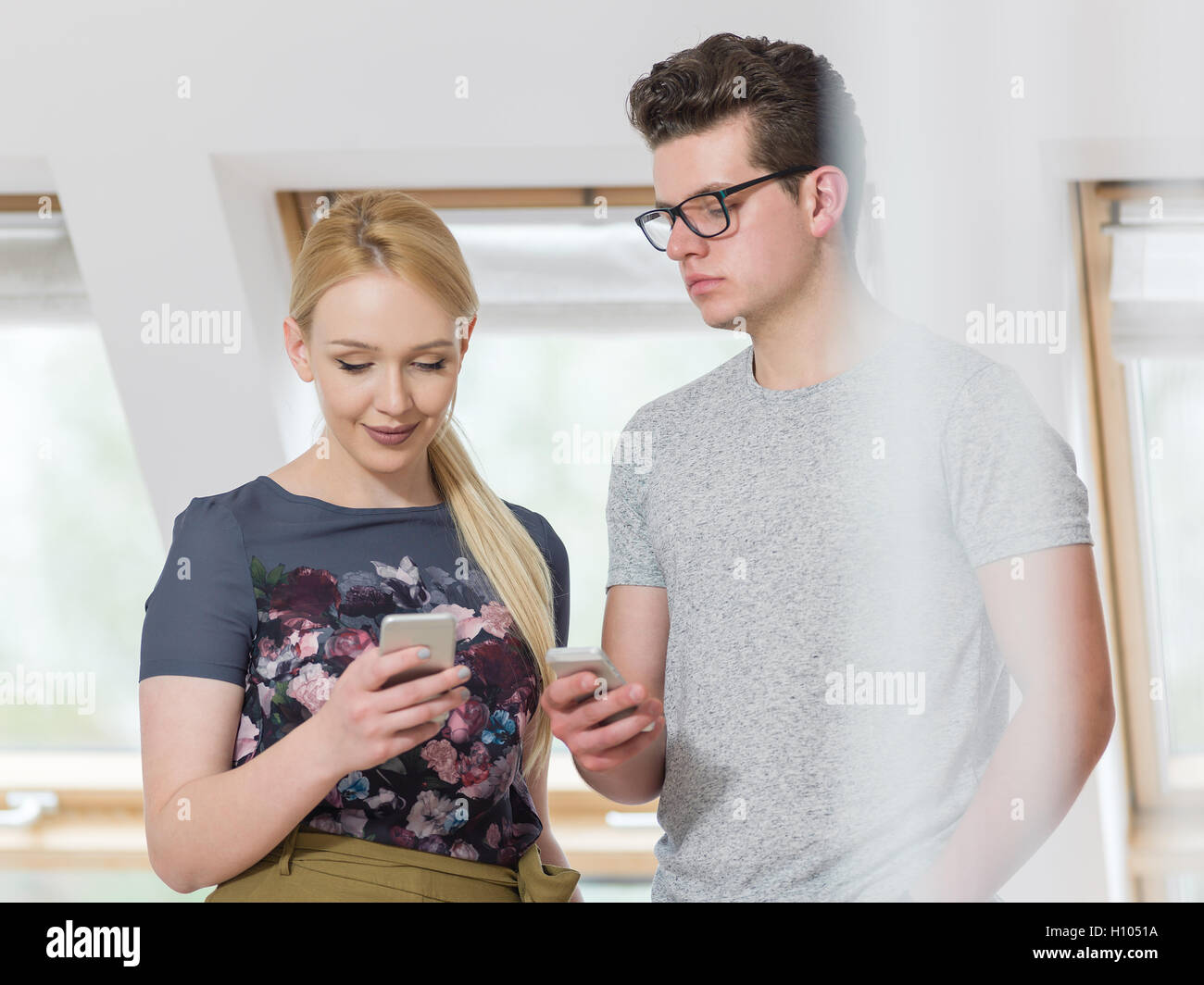 Close-up of friends using their phones and having fun together Stock ...