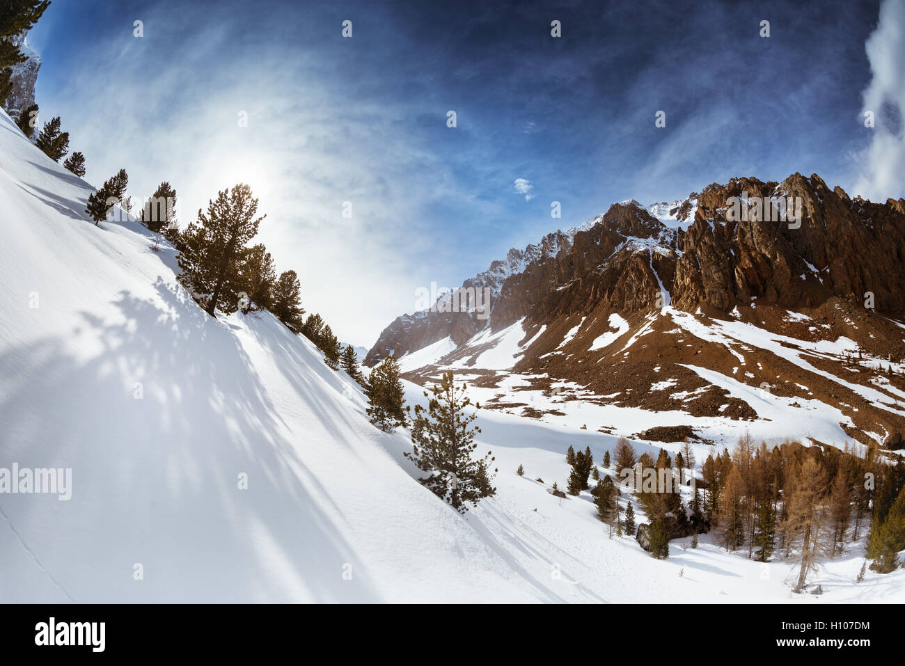 Snowy mountains rocks cloudy sky Stock Photo - Alamy