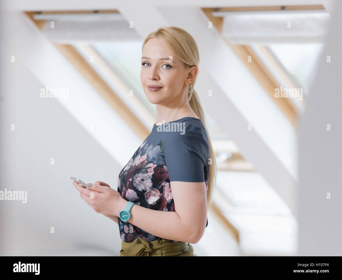 Pretty young business woman using mobile phone in startup office Stock ...