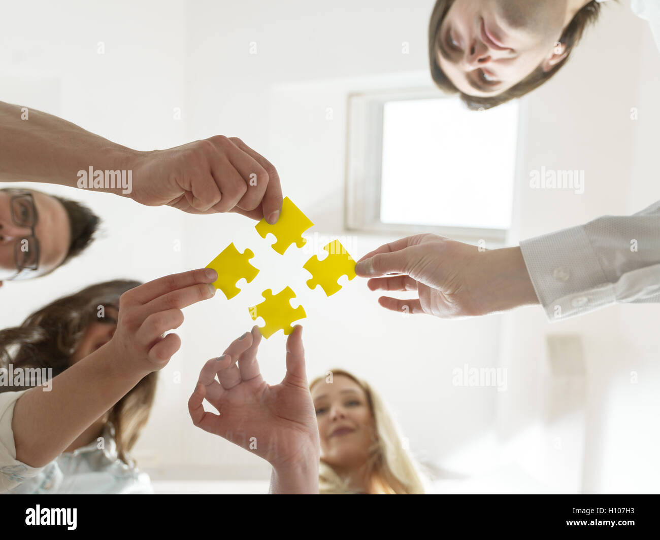 Group of business people assembling jigsaw puzzle and represent team ...