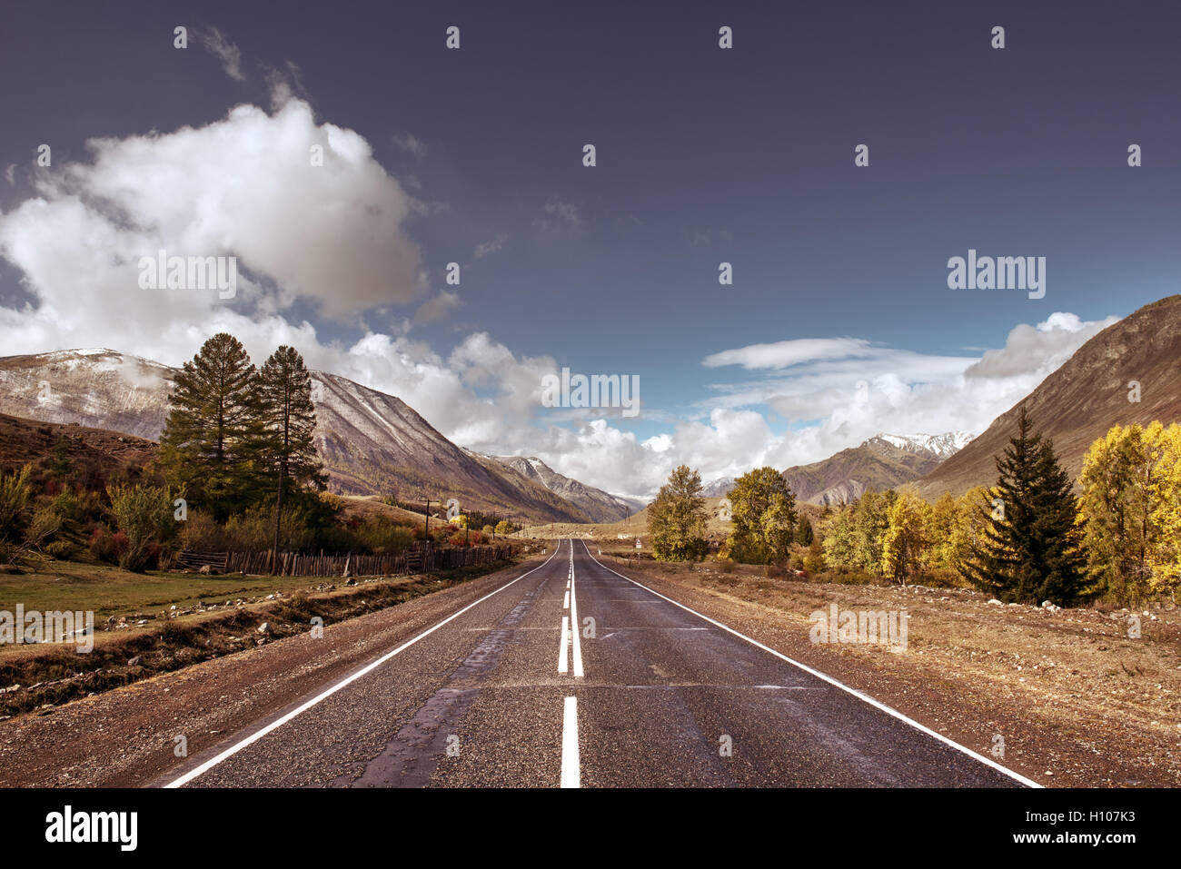 Old highway against mountains and a cloudy sky Stock Photo - Alamy