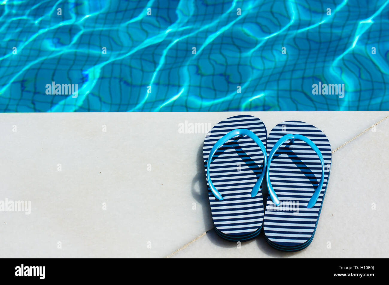 Stripped flip-flop summer shoes on poolside Stock Photo - Alamy