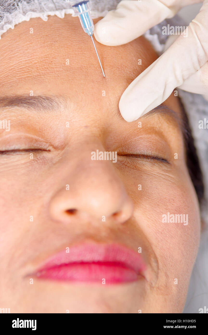 Closeup womans face receiving anti wrinkle injections with syringe ...