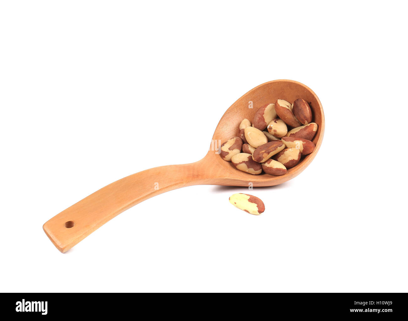 Wooden spoon with brazil nuts Stock Photo - Alamy