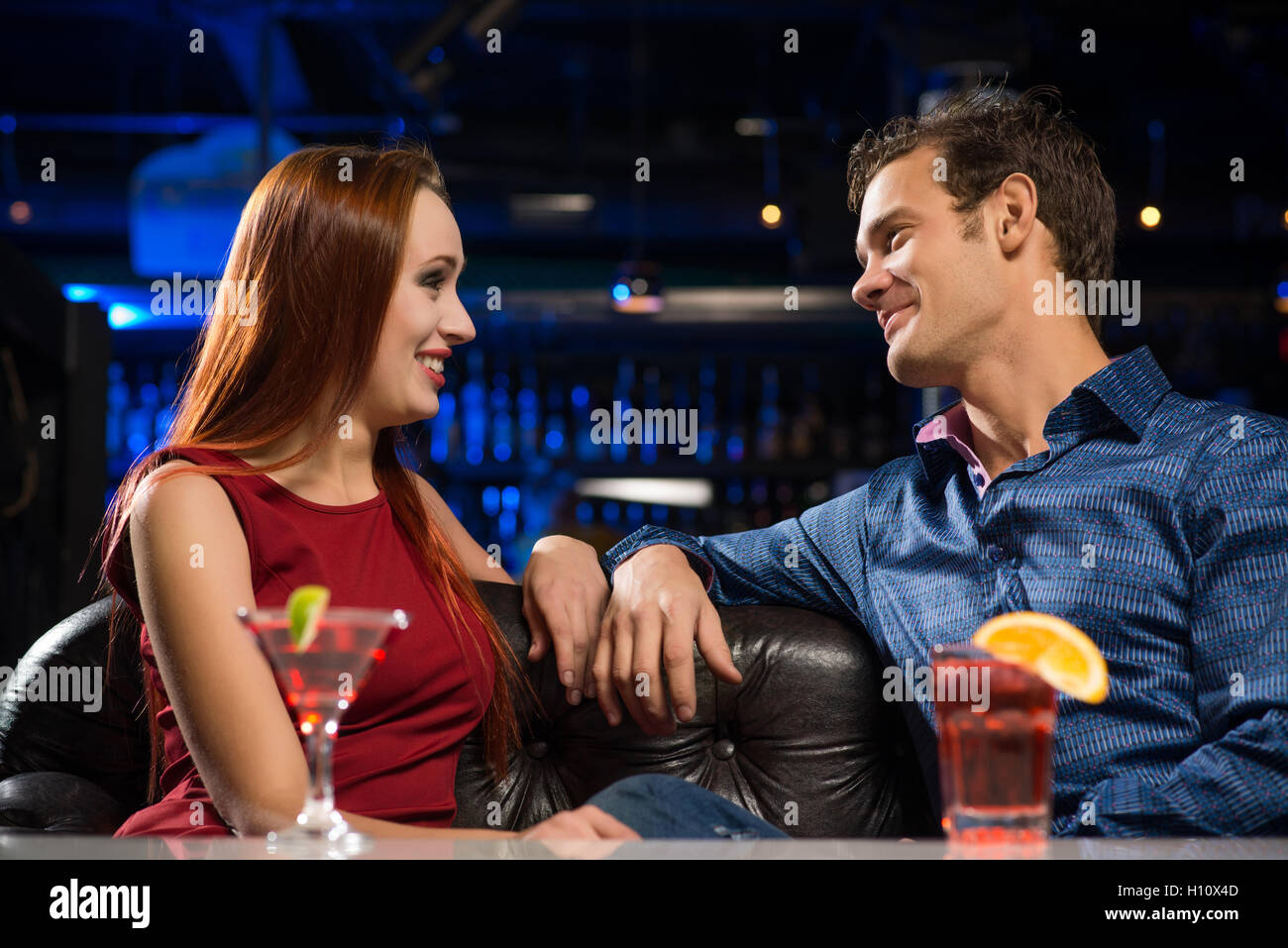 Young couple talking in a nightclub Stock Photo - Alamy
