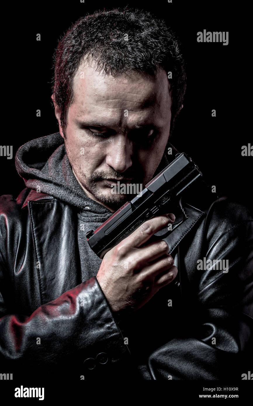 Intruder, thief, armed man with black leather jacket, dangerous Stock ...