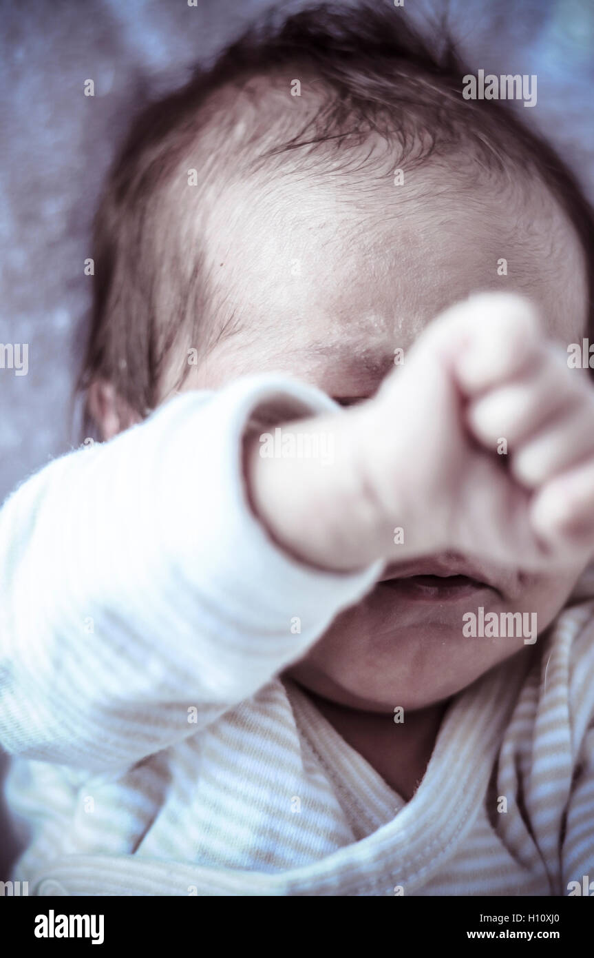 new born baby curled up sleeping on a blanket, multiple expressi Stock ...
