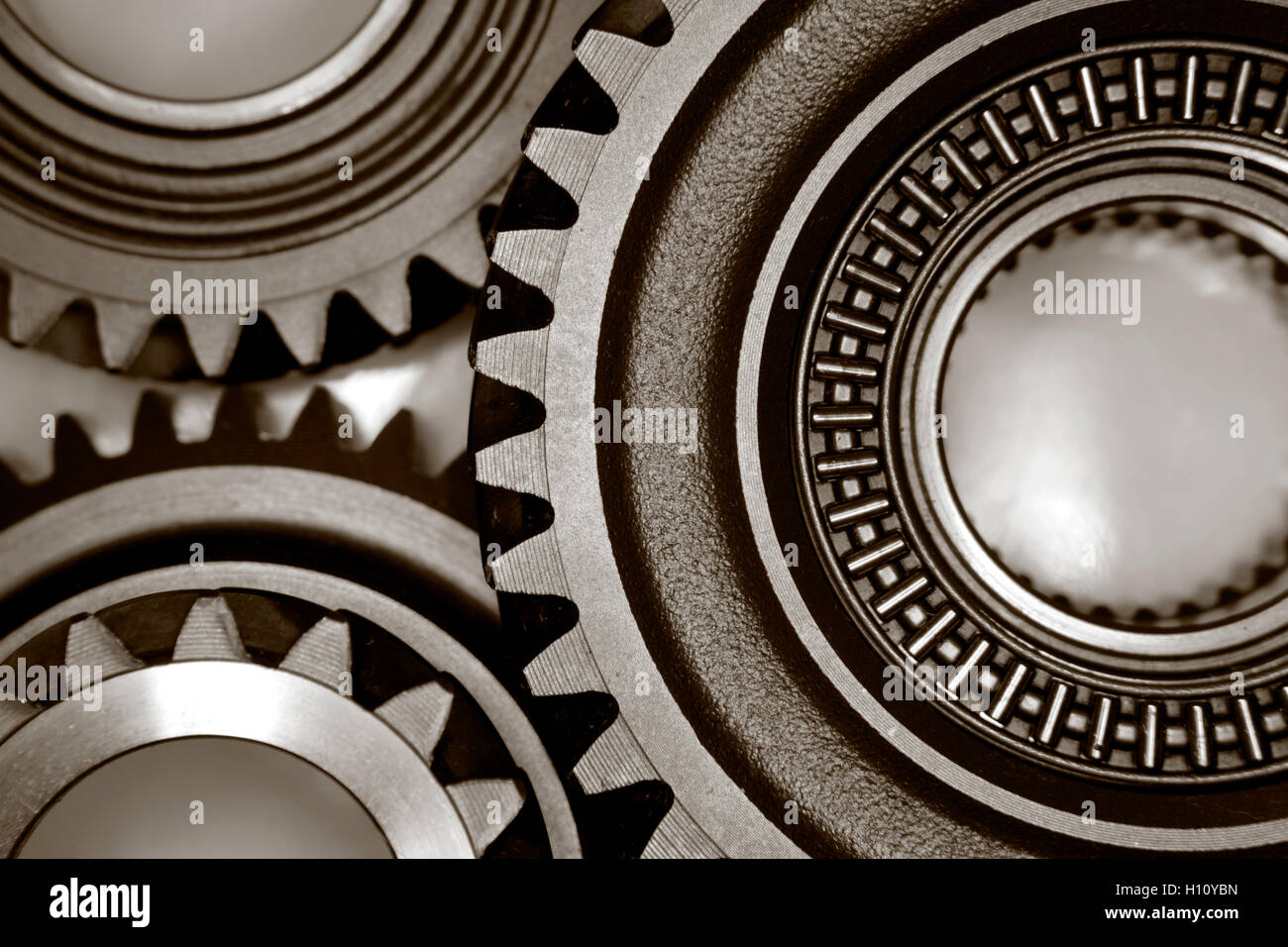 Metal cog gears joining together Stock Photo - Alamy