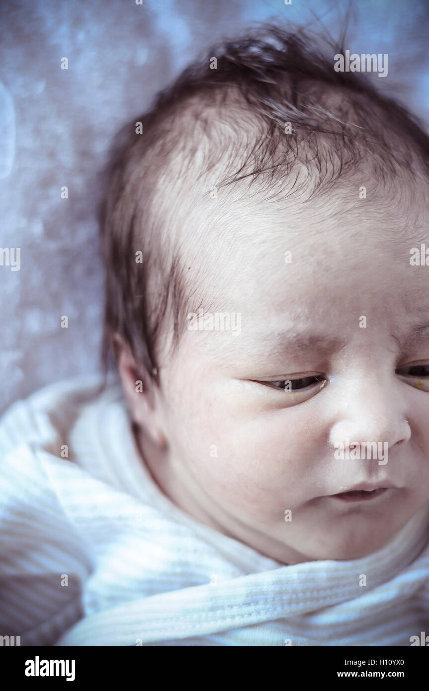 new born baby curled up sleeping on a blanket, multiple expressi Stock ...