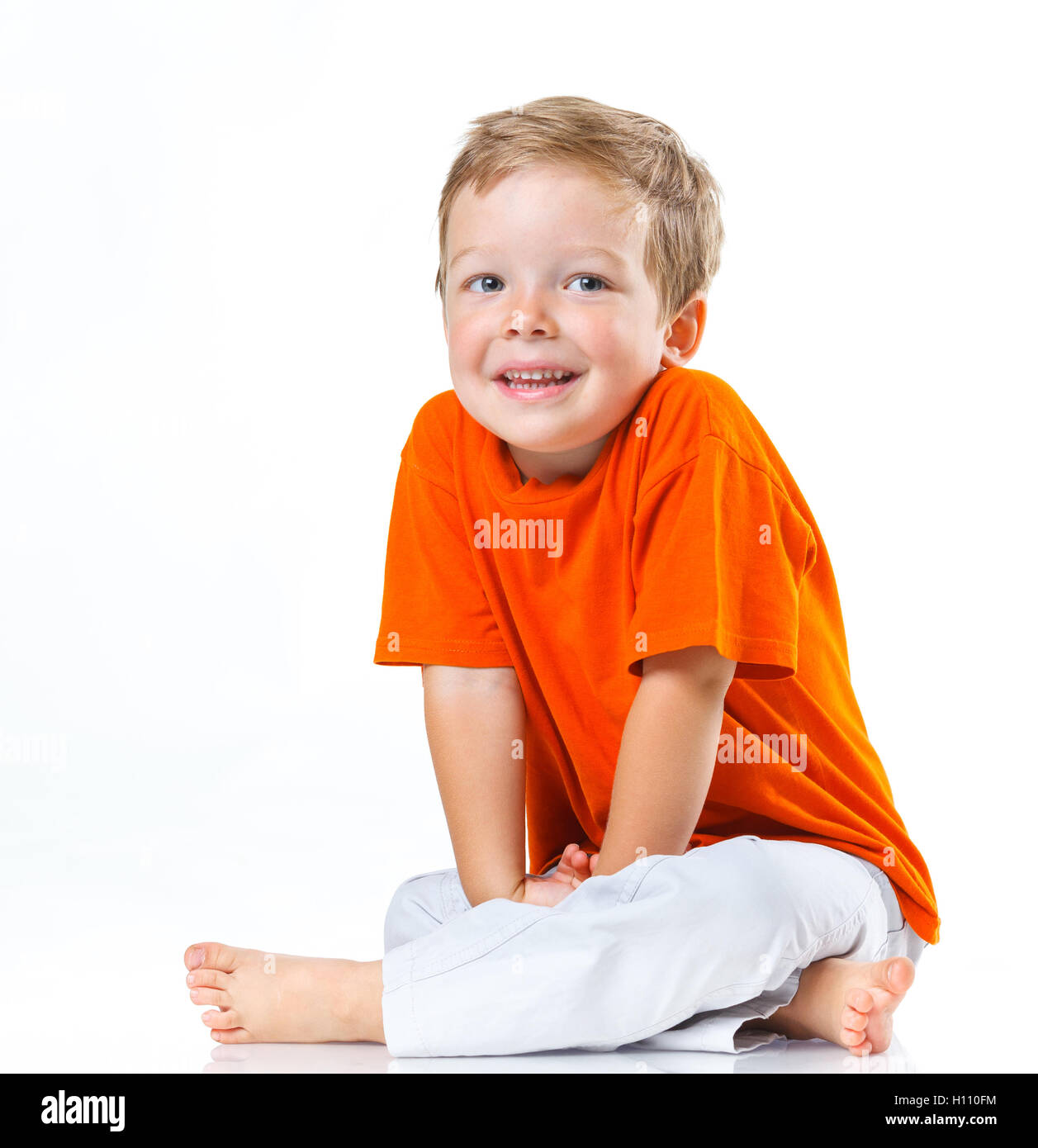 Happy boy sitting on the floor Stock Photo - Alamy