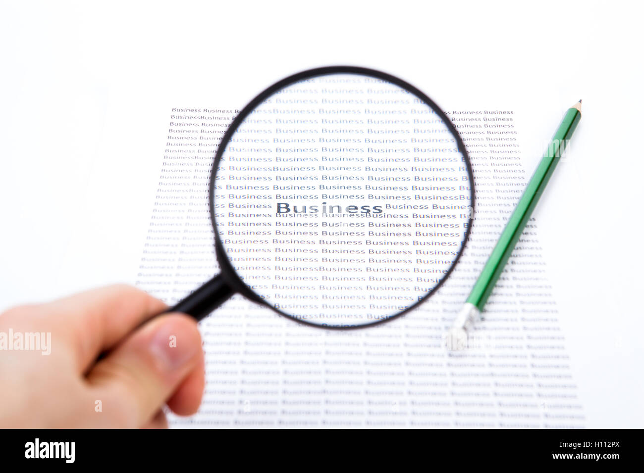 Magnifier, pencil and paper Stock Photo - Alamy