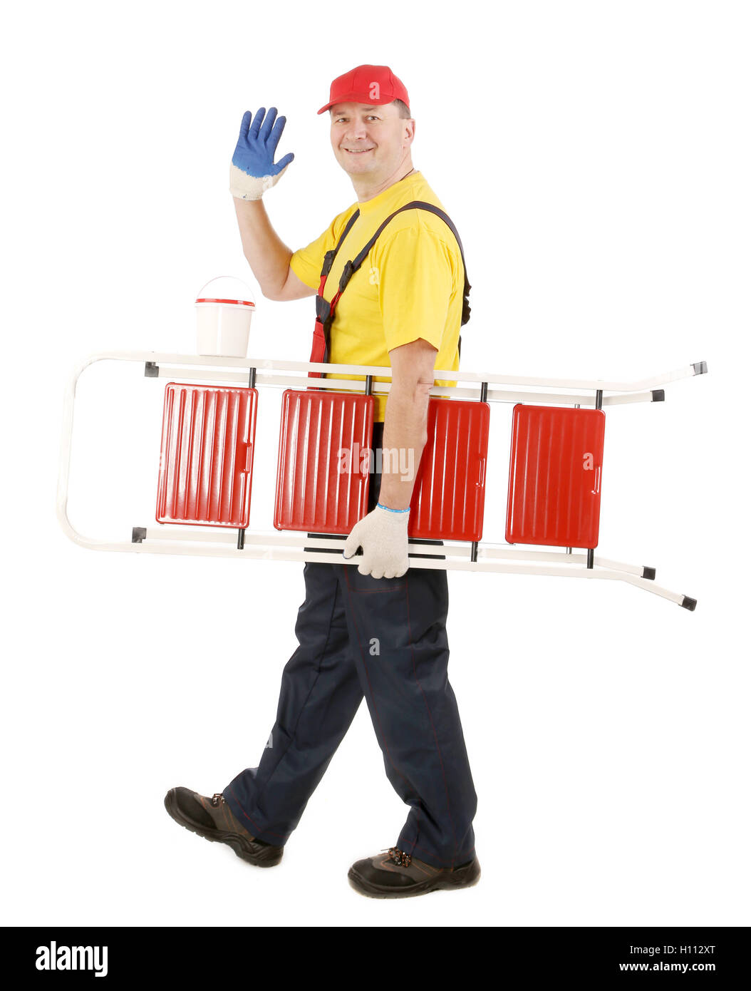 Worker with ladder smiling Stock Photo - Alamy