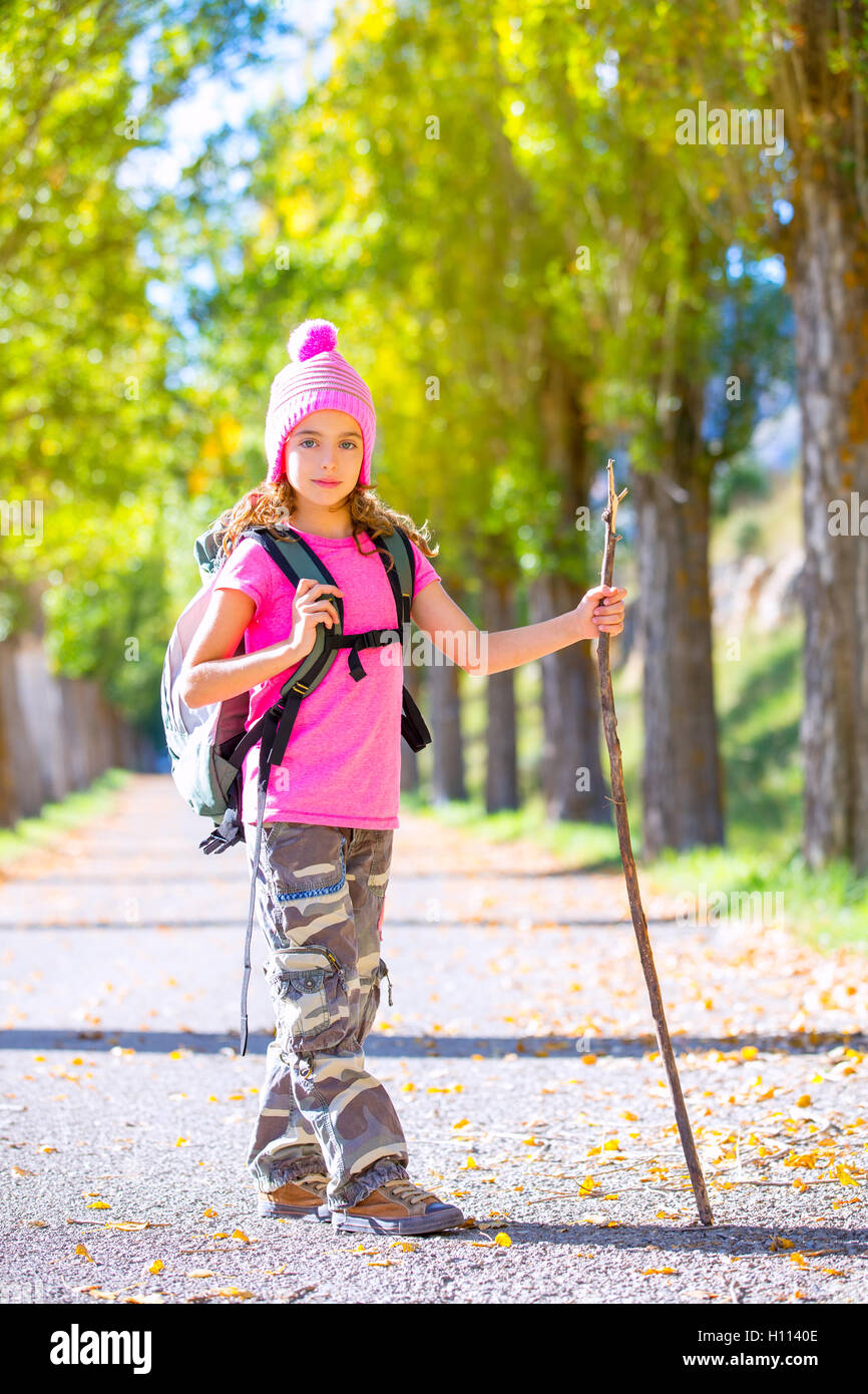 hiking kid girl with walking stick and backpack in autumn Stock Photo ...