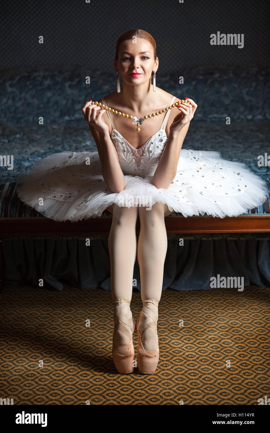 Ballerina holding pearl necklace and smiling Stock Photo - Alamy