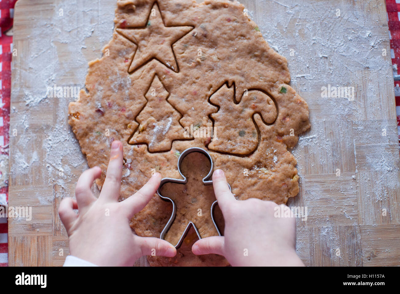 Child hands making from dough gingerbread man Stock Photo - Alamy