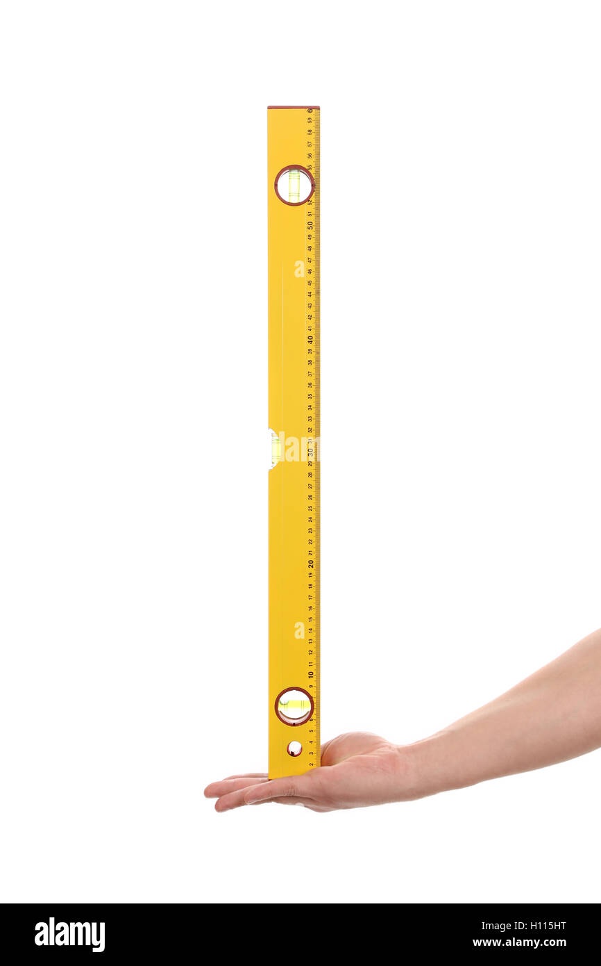 Yellow building level in hand Stock Photo - Alamy
