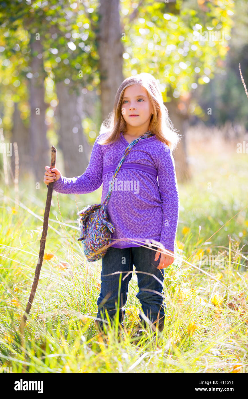 Hiking kid girl with walking stick in autum poplar forest Stock Photo ...