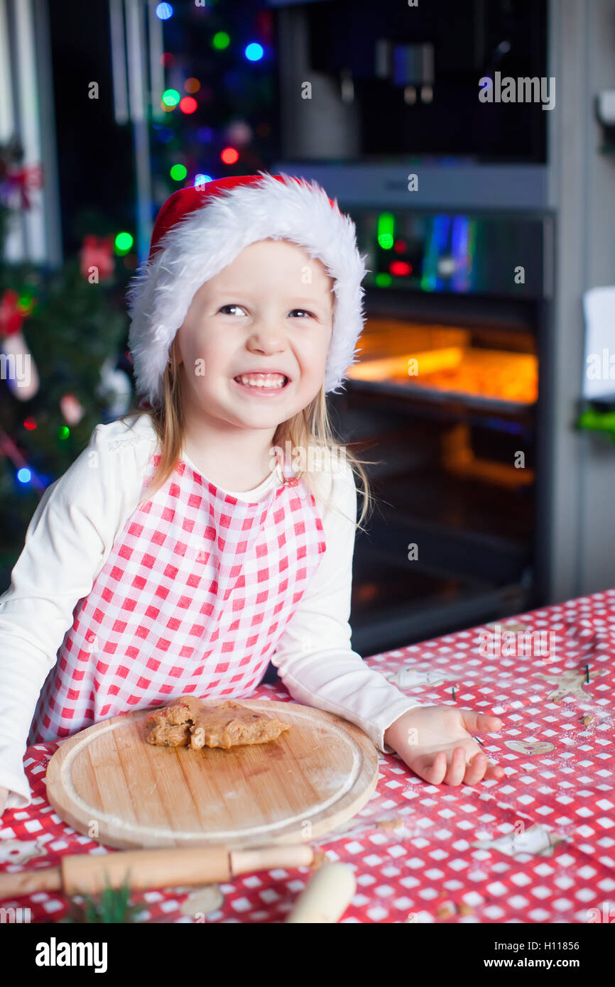 Portrait of happy cute little girl in the kitchen baking gingerbread Stock Photo - Alamy
