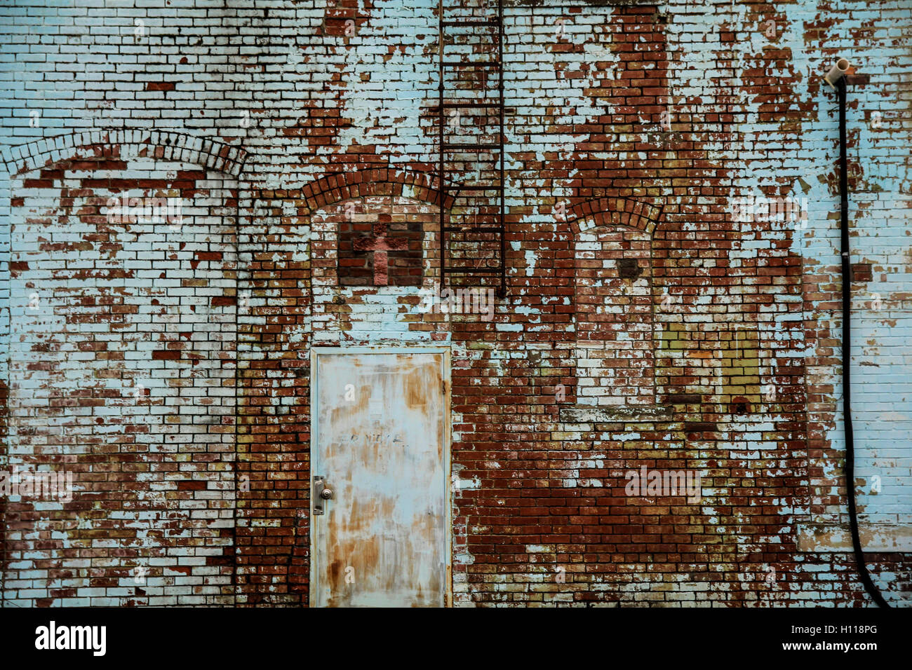 The facade of a brick building with peeling paint Stock Photo - Alamy
