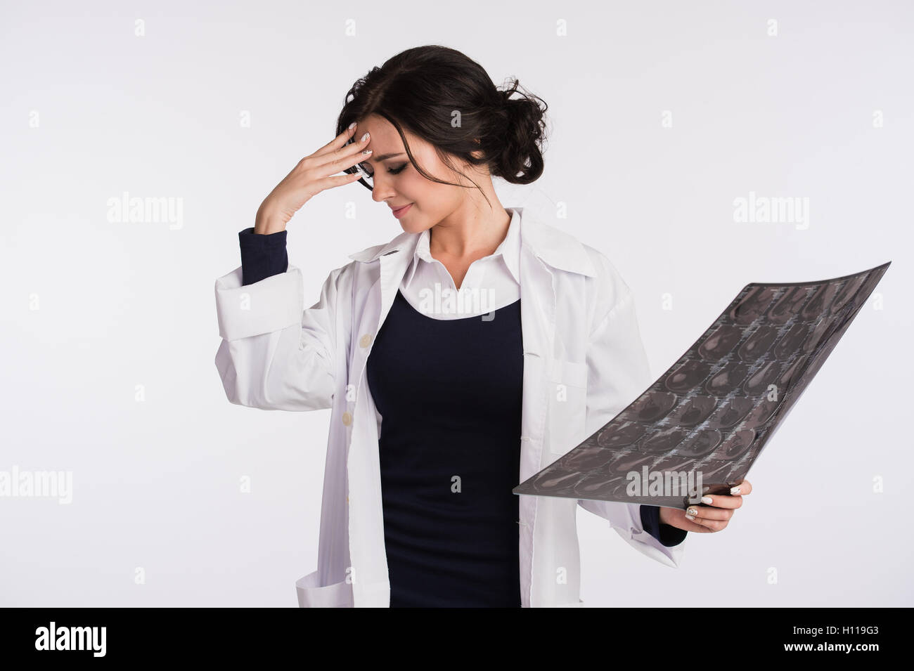 Beautiful female doctor nurse holding x-ray tired Stock Photo - Alamy
