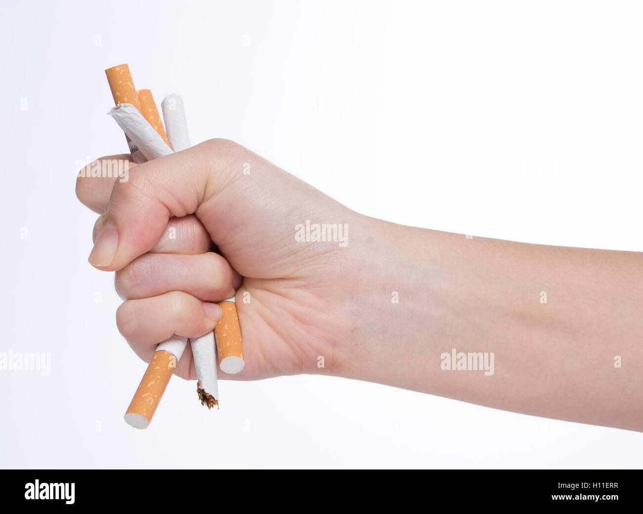 No smoking concept, closeup of clenched fist grasping cigarettes, no ...