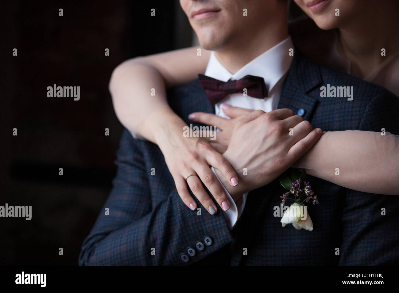 Wedding couple holding hands and hugging Stock Photo - Alamy