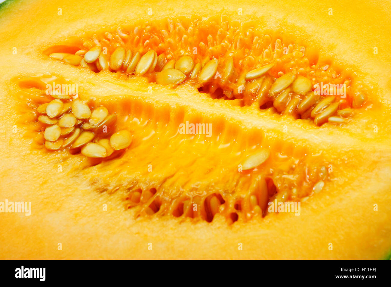 Close up of orange melon fruit and grains Stock Photo - Alamy