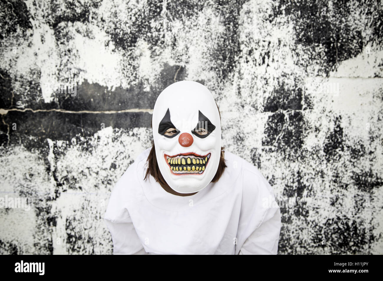 Crazy clown mask halloween costume and fear Stock Photo - Alamy