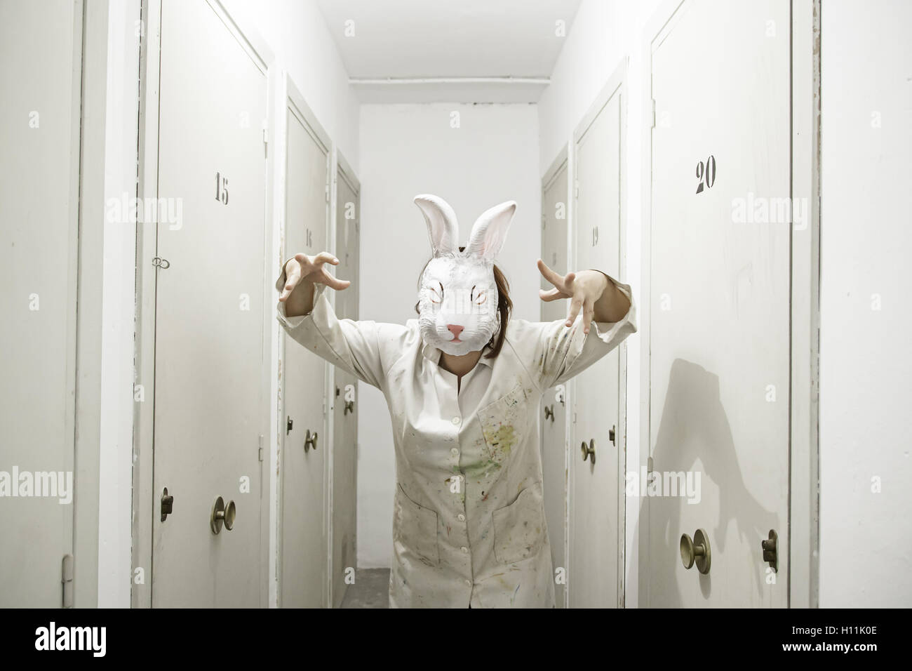 Masked woman in home interior scared rabbit Stock Photo - Alamy