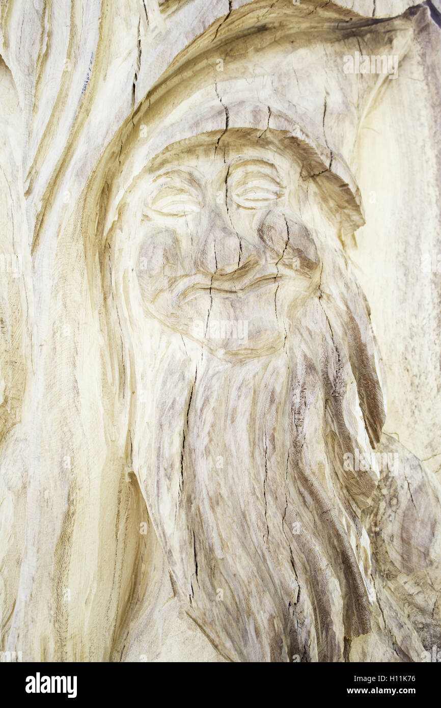 Elf carved tree with happy face, emotion Stock Photo - Alamy