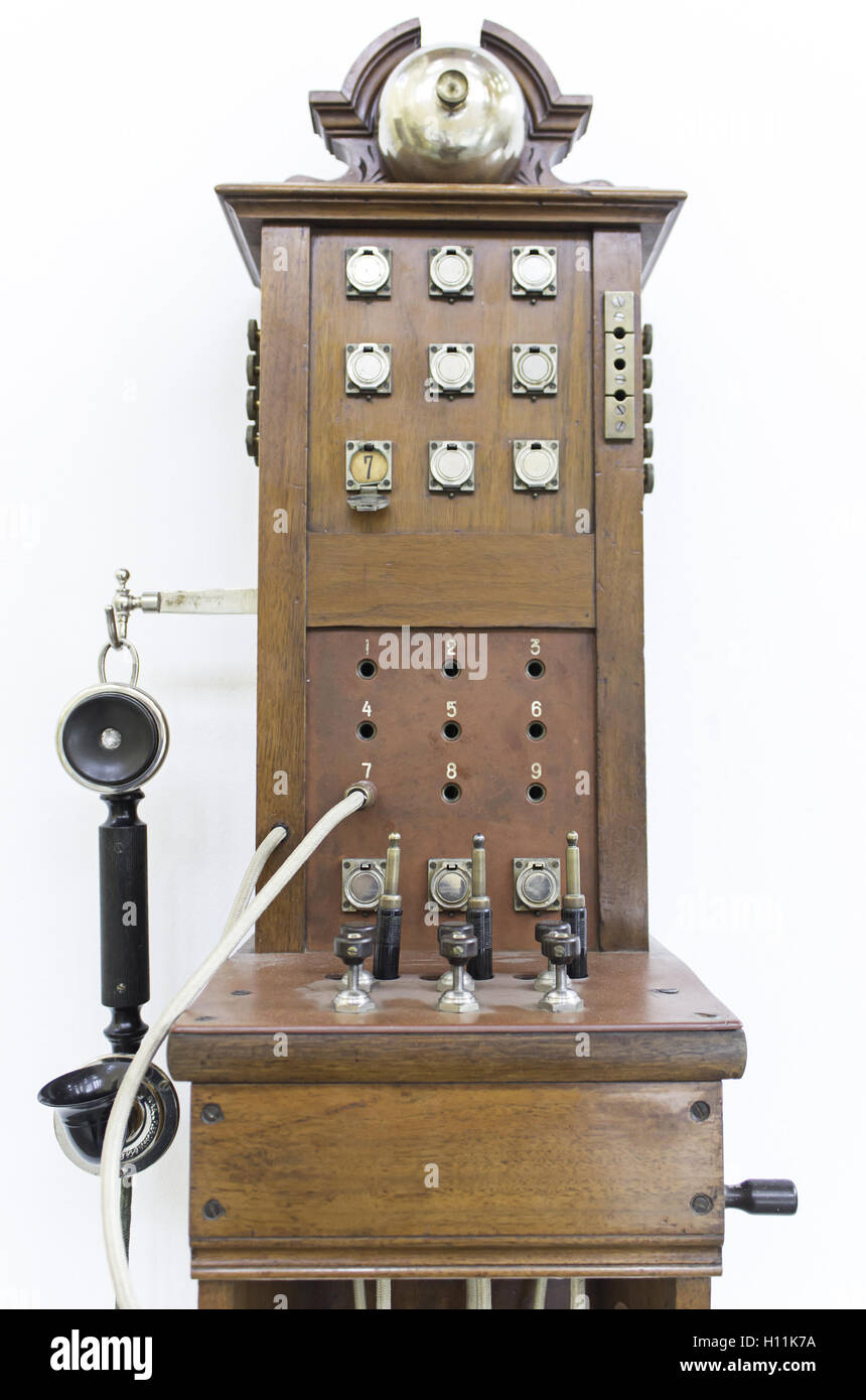 Old telephone hanging on wall pegs, communication Stock Photo - Alamy