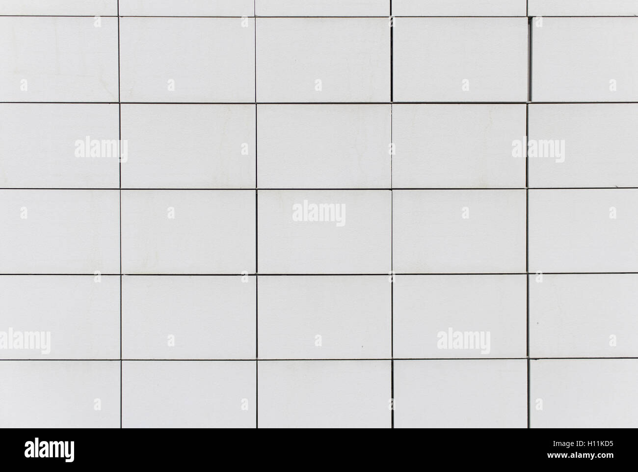 Urban square tiles in wall construction Stock Photo - Alamy
