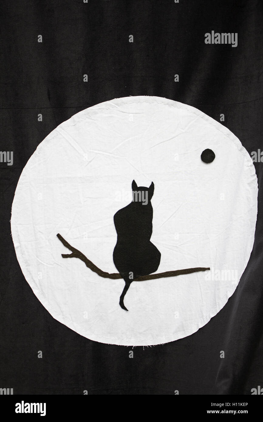 Black cat sitting on branch and moon symbol Stock Photo - Alamy