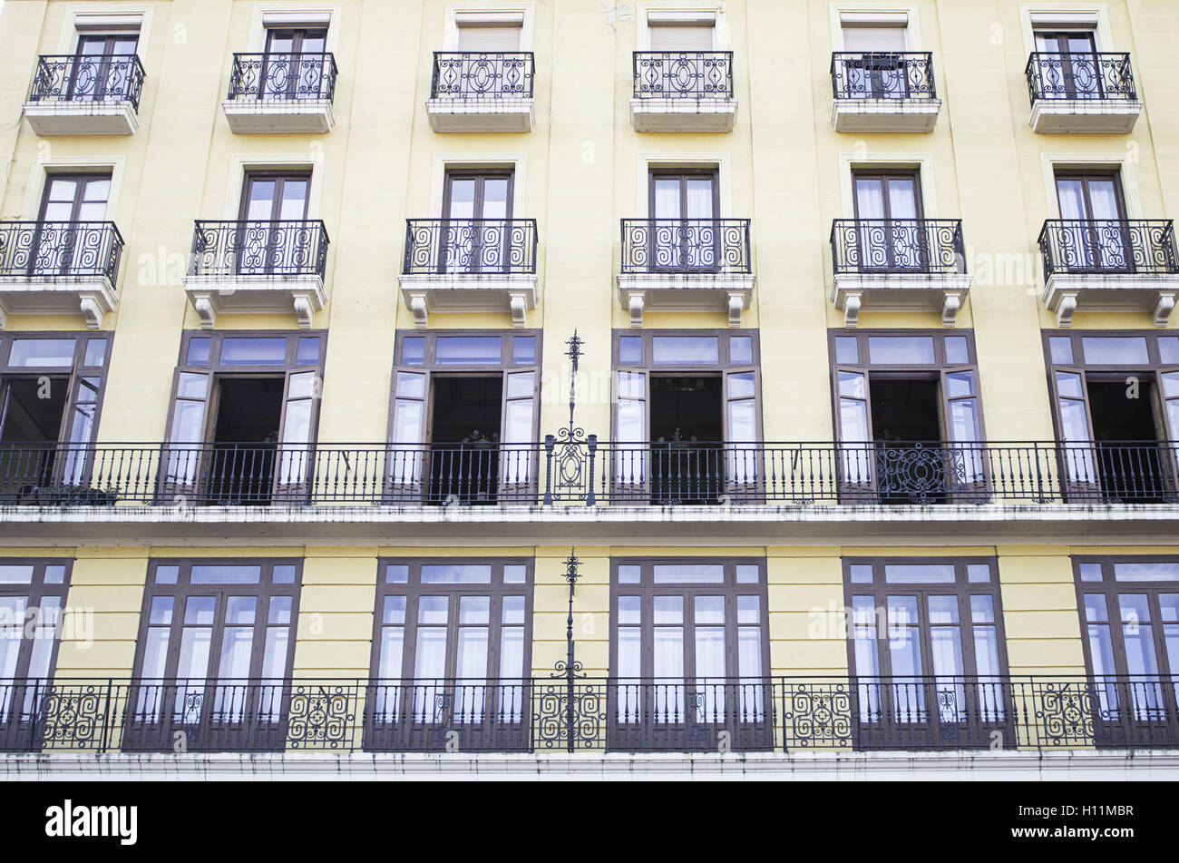 Modern yellow building in urban street construction Stock Photo - Alamy
