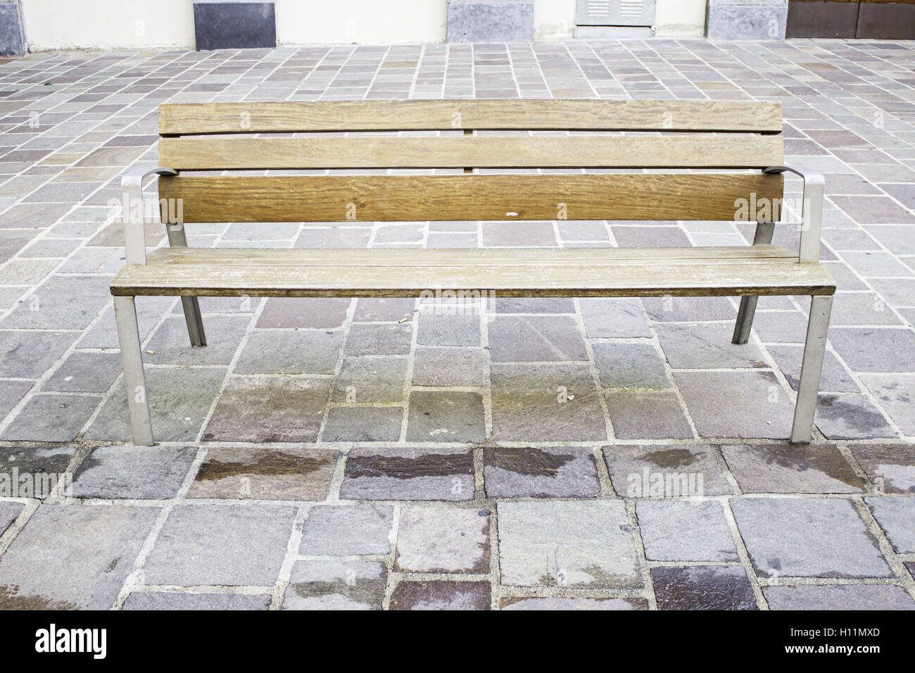 Wooden Bench in street city urban Stock Photo - Alamy