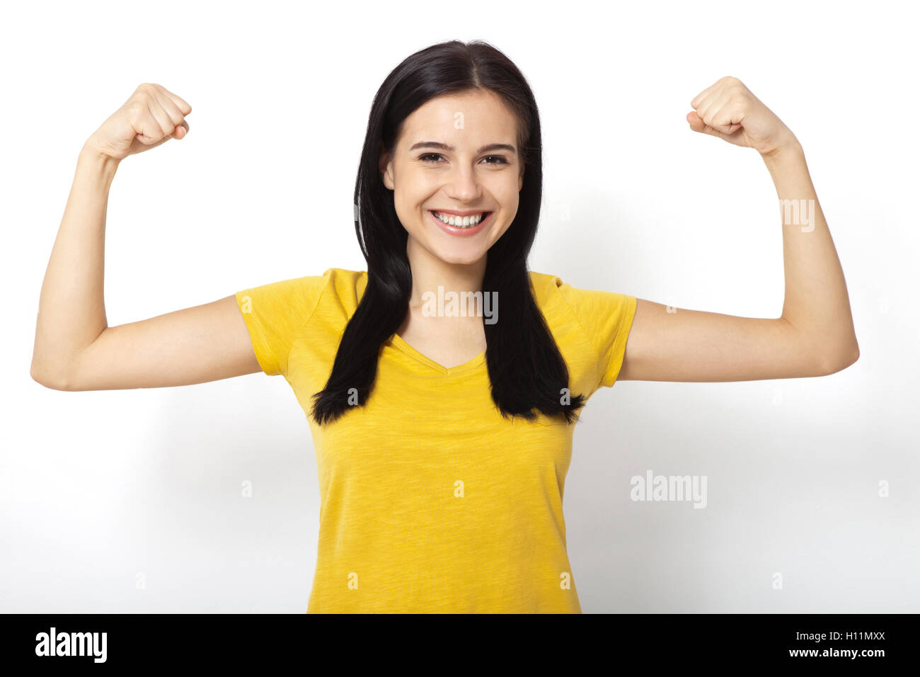 Strong woman. Beautiful girl showing her muscularity, looking at camera ...