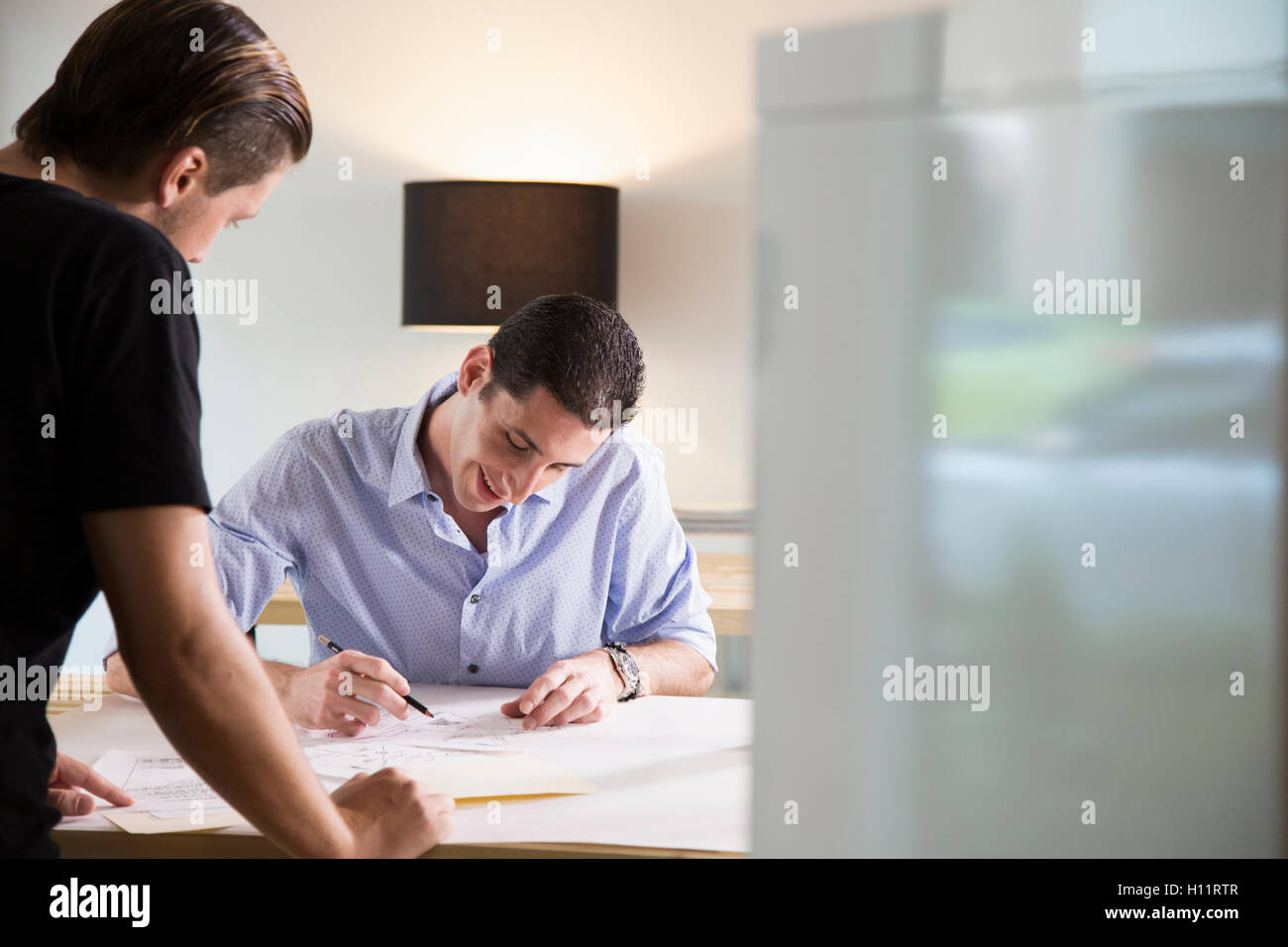 Close up of two men working in a modern office Stock Photo - Alamy