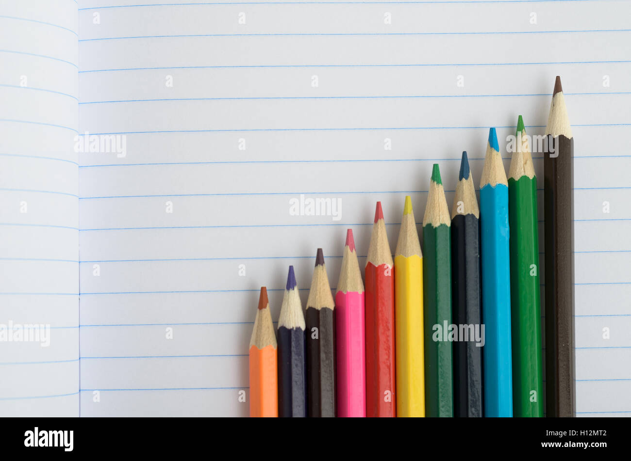 Colored pencils and paper Stock Photo - Alamy