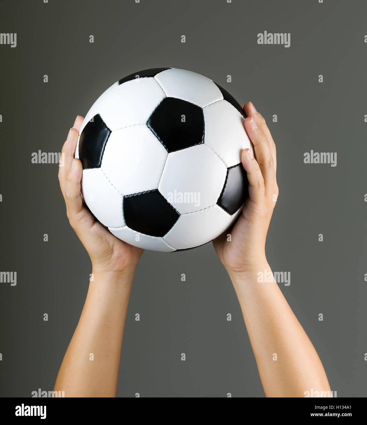 Hand holding soccer ball Stock Photo - Alamy
