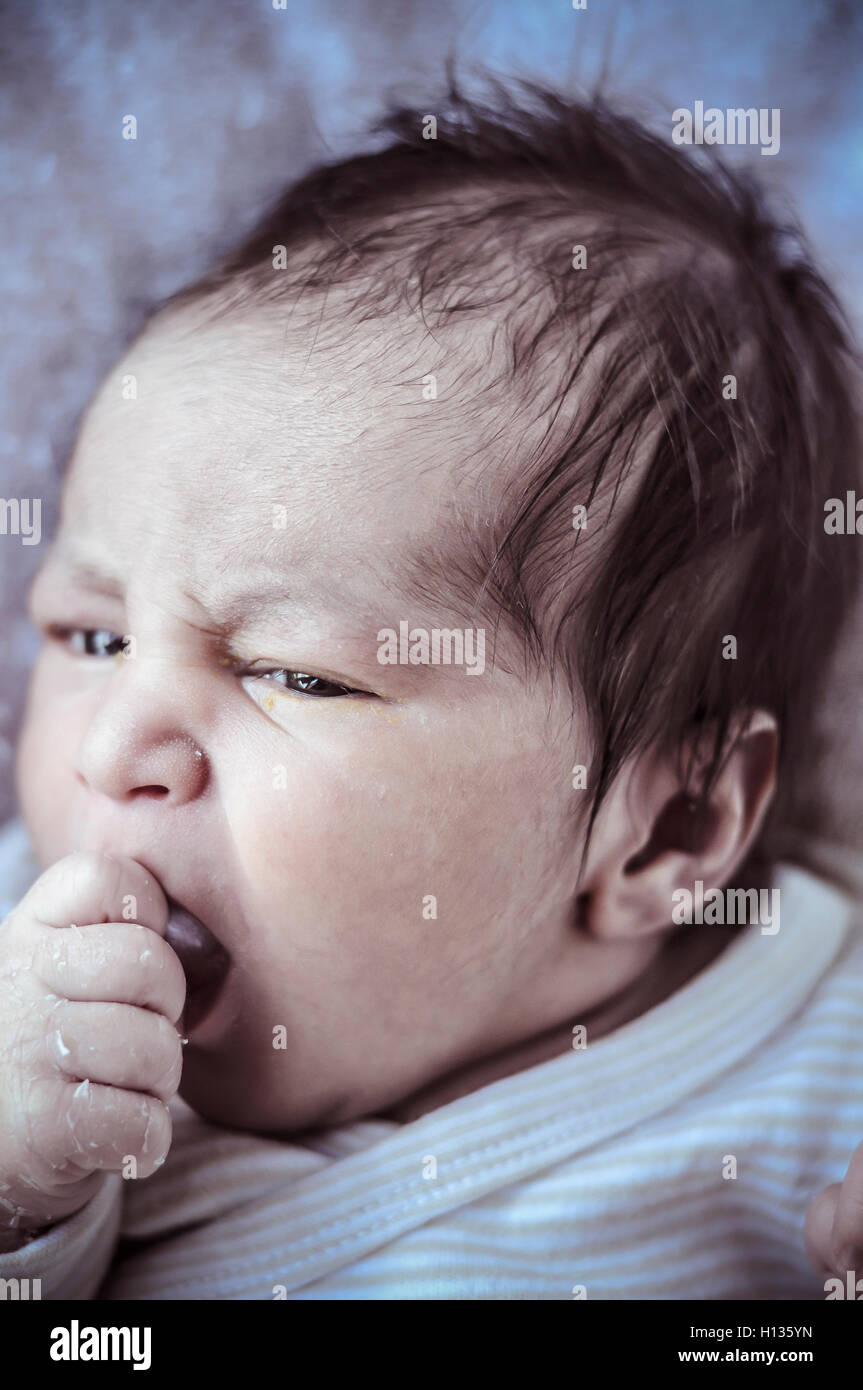 new born baby curled up sleeping on a blanket, multiple expressi Stock ...