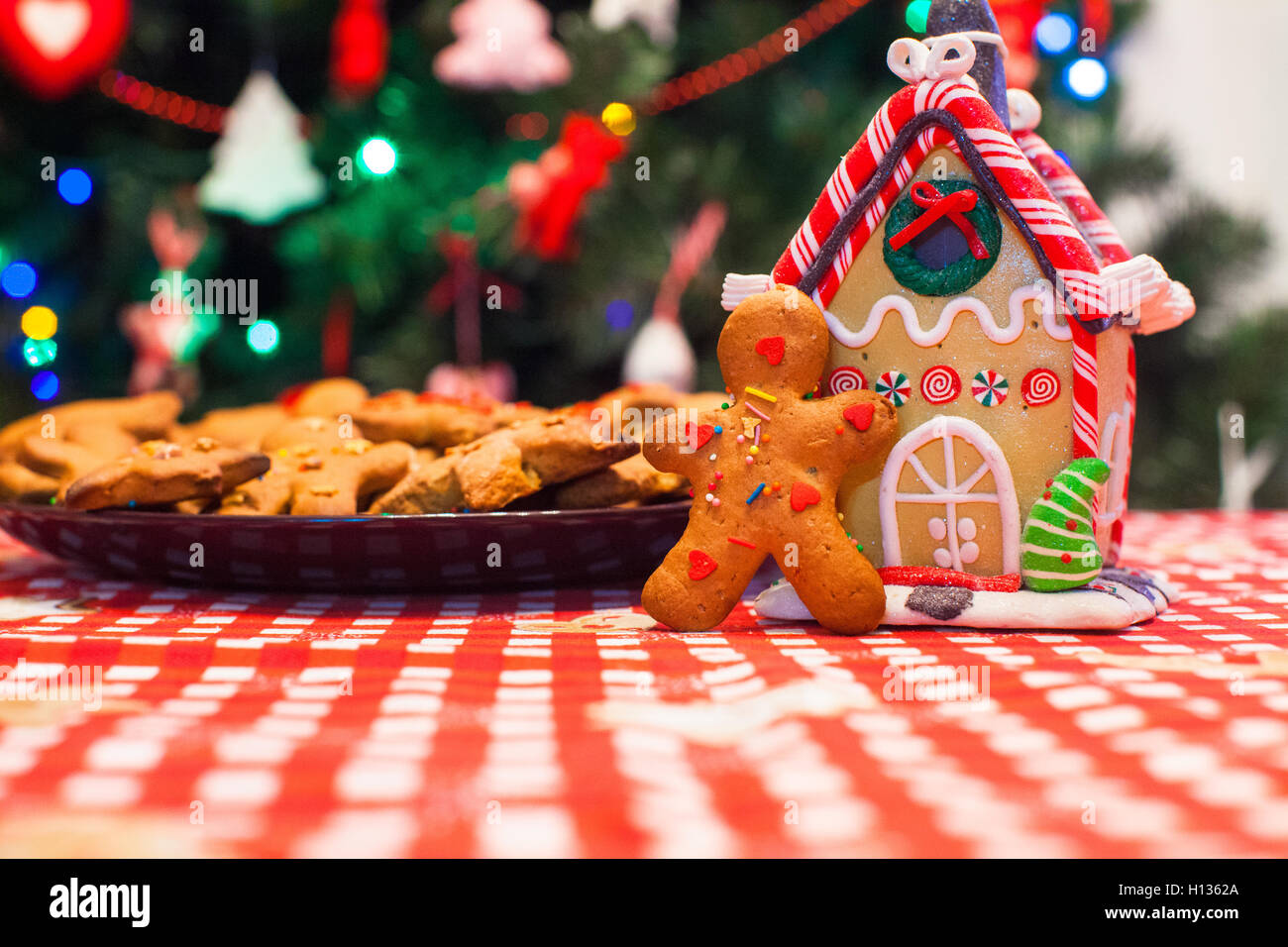 Cute gingerbread man in front of his candy ginger house background the ...