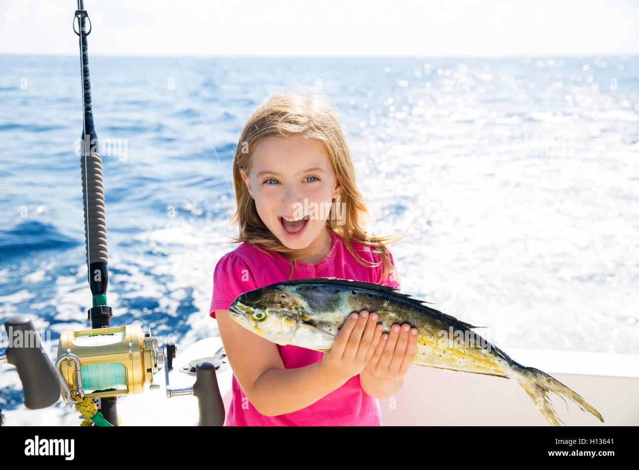 Blond kid girl fishing Dorado Mahi-mahi fish happy catch Stock Photo ...